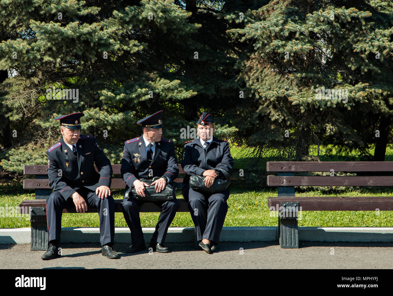 Moscow Russia, May 9, 2018: police officers sitting on a bench in sunny ...