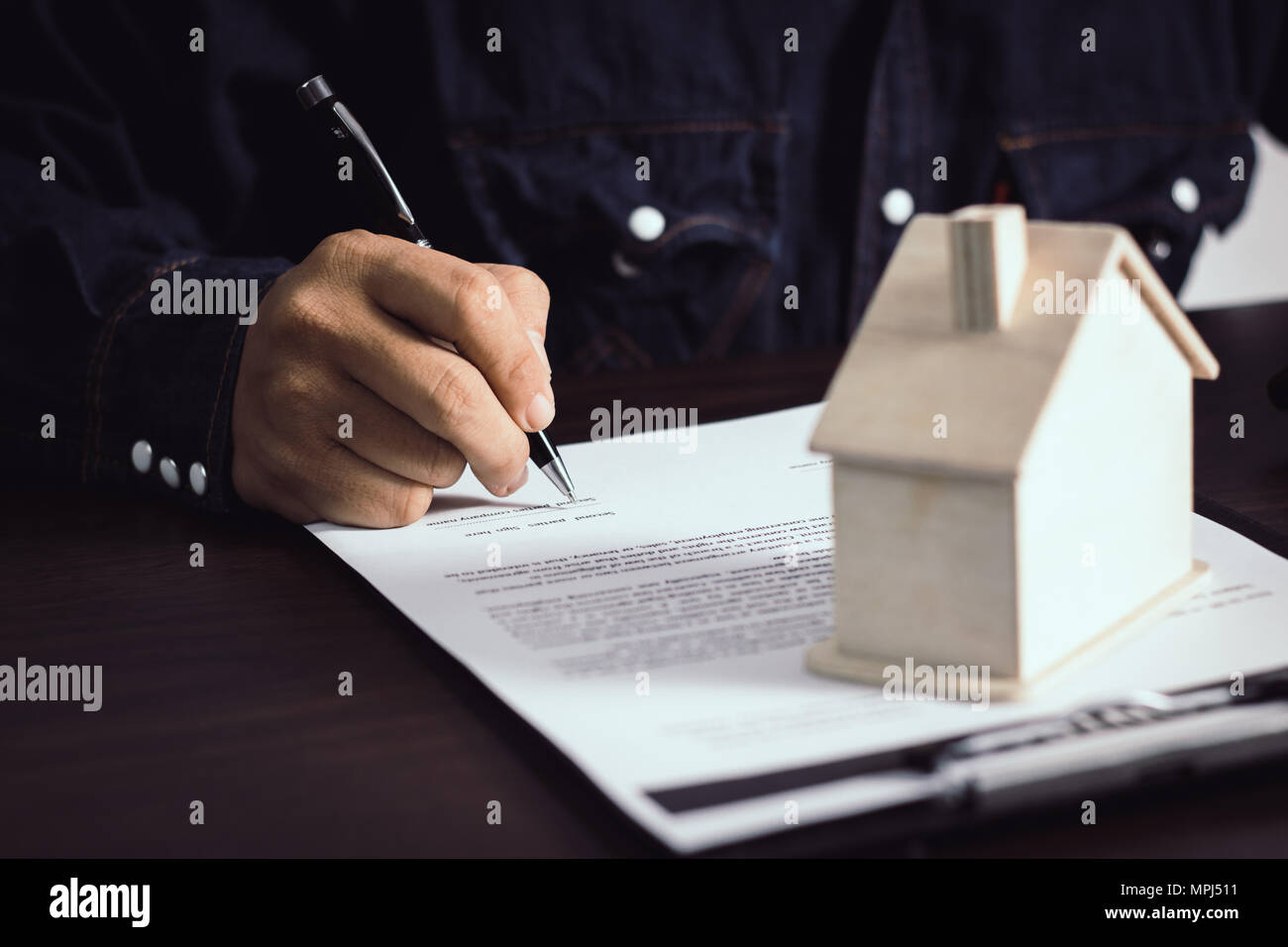 man writing and sign on contract of house after finishing selling and ...