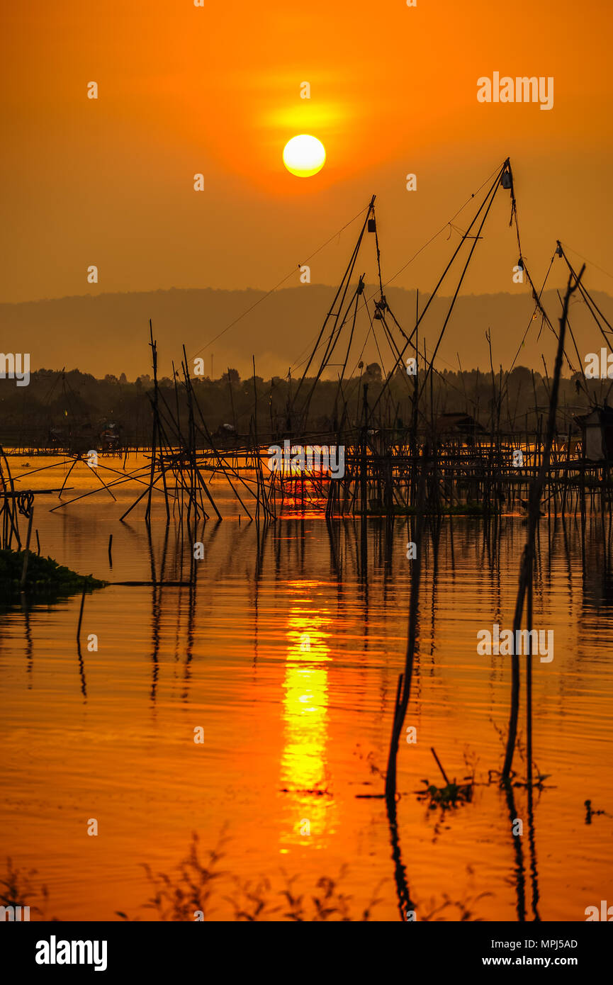 Traditional bamboo and wooden fishing tools installed in rural swamp ...