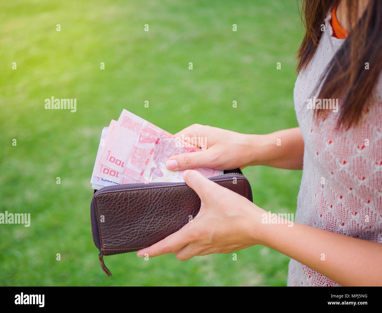 Woman taking cash out from hi-res stock photography and images - Alamy