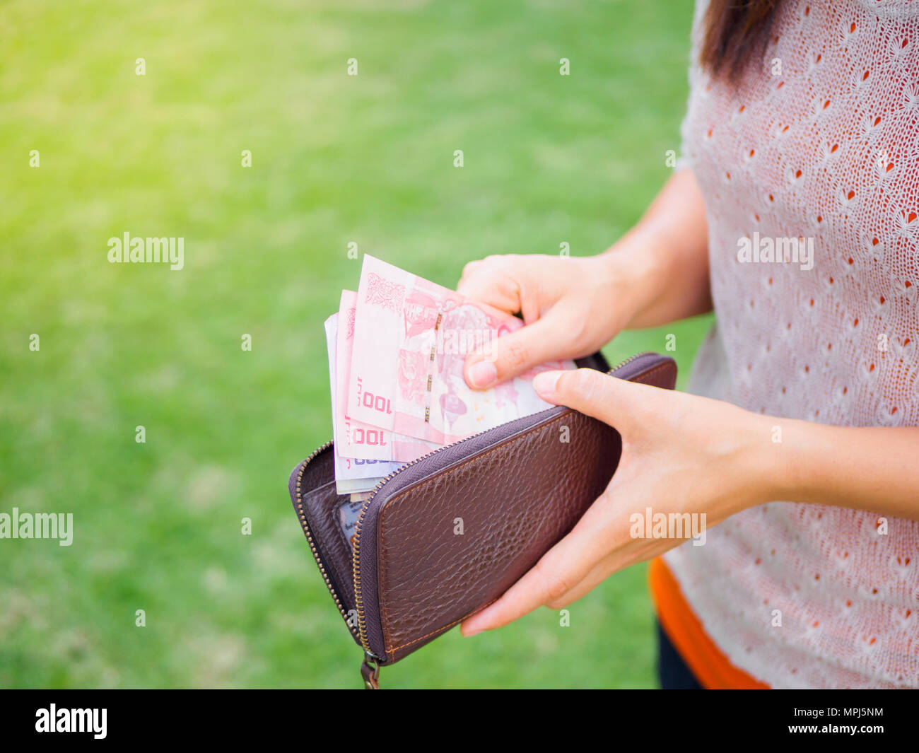 Woman taking money from pocket hi-res stock photography and images - Alamy