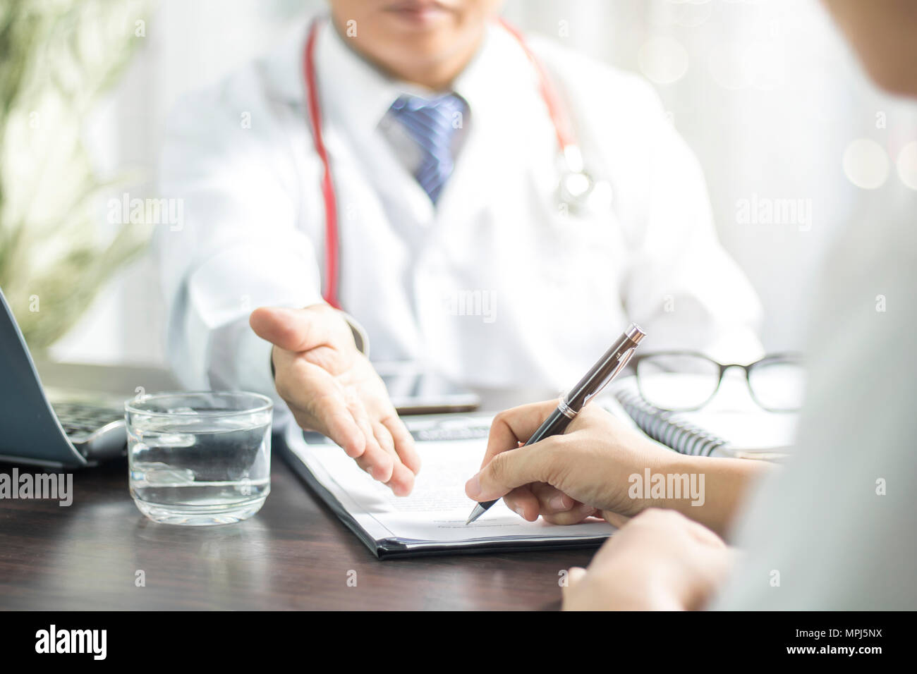 Doctor introduces patient signing on medical records before treat ...