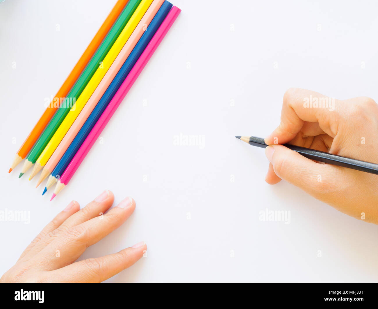 Woman hand with pencil writing on white paper Stock Photo - Alamy