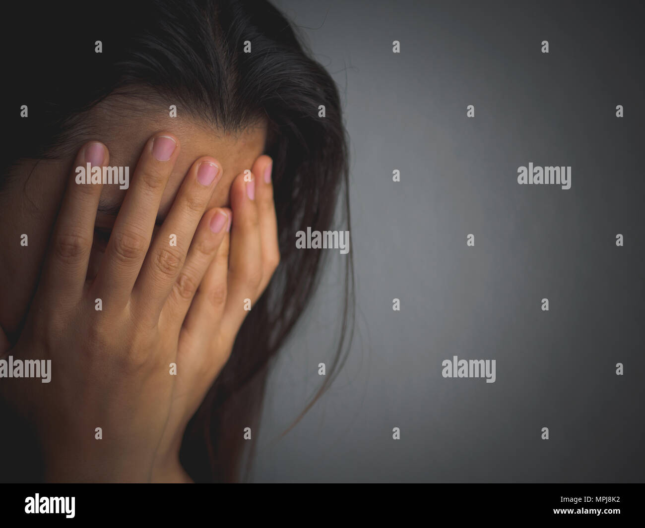Sad woman sitting alone in a empty room Stock Photo - Alamy