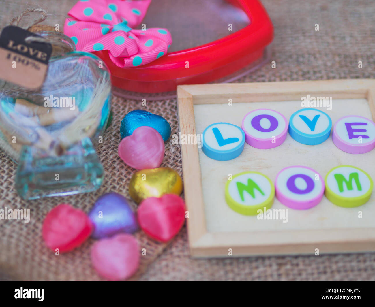 love mom spelled with colorful alphabet blocks and a red heart isolated ...