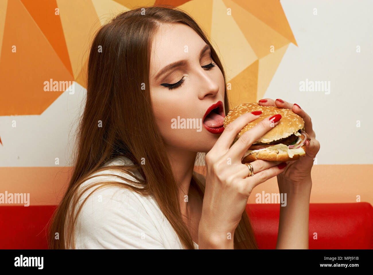 Attractive woman eating burger hi-res stock photography and images - Alamy