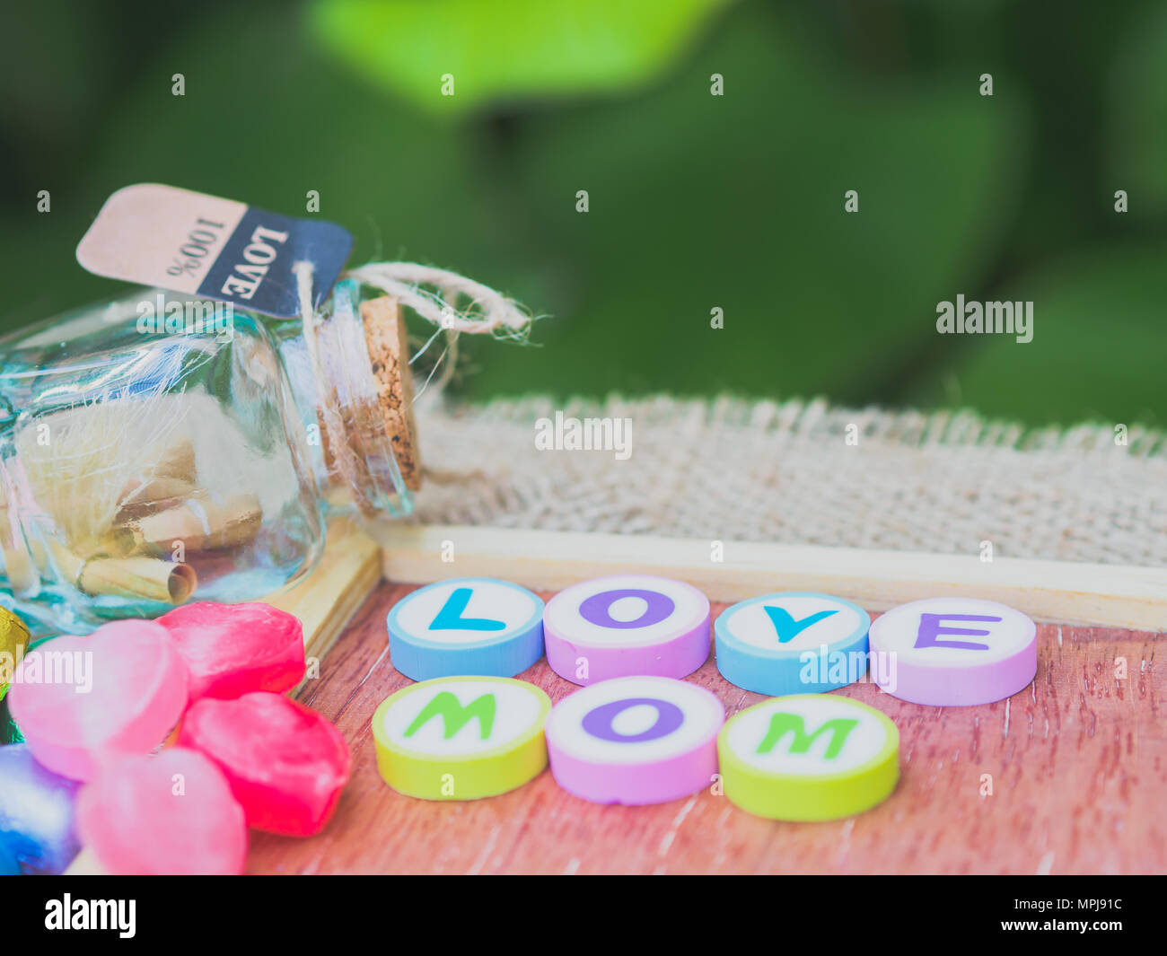 love mom spelled with colorful alphabet blocks and a red heart isolated ...