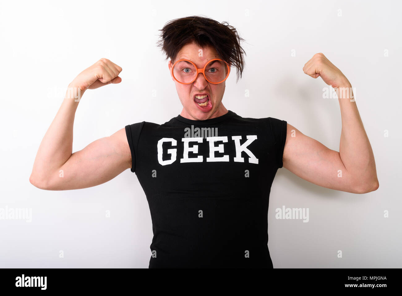 Studio shot of young nerd man flexing both arms while wearing ey Stock ...