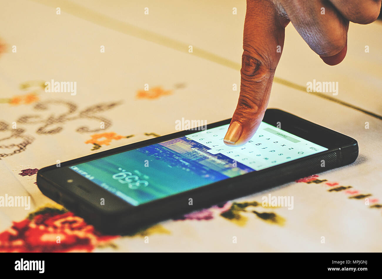 Finger touching the screen of a smartphone Stock Photo - Alamy