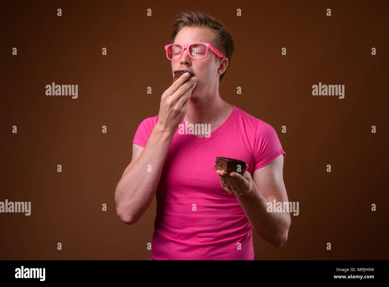 Young man eating sweet chocolate hi-res stock photography and images ...