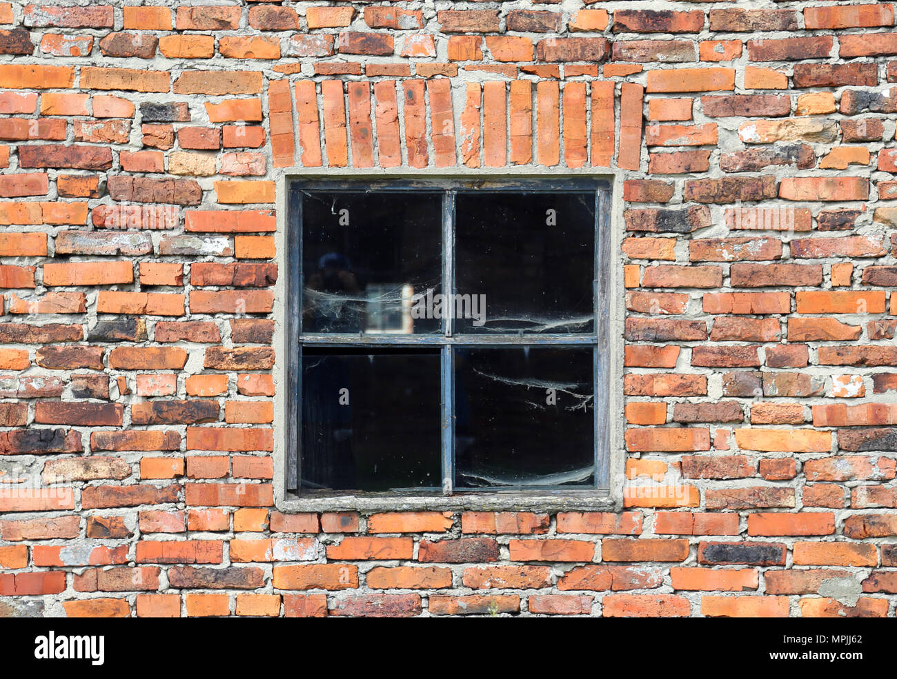 wedged glass window between the red bricks of a wall Stock Photo - Alamy