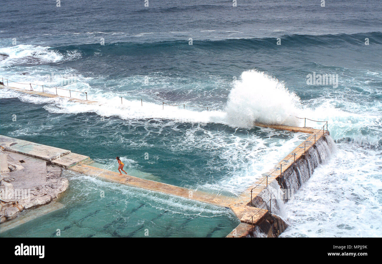 A swimmer by the sea water pool at Icebergs Swimming Club with huge ...