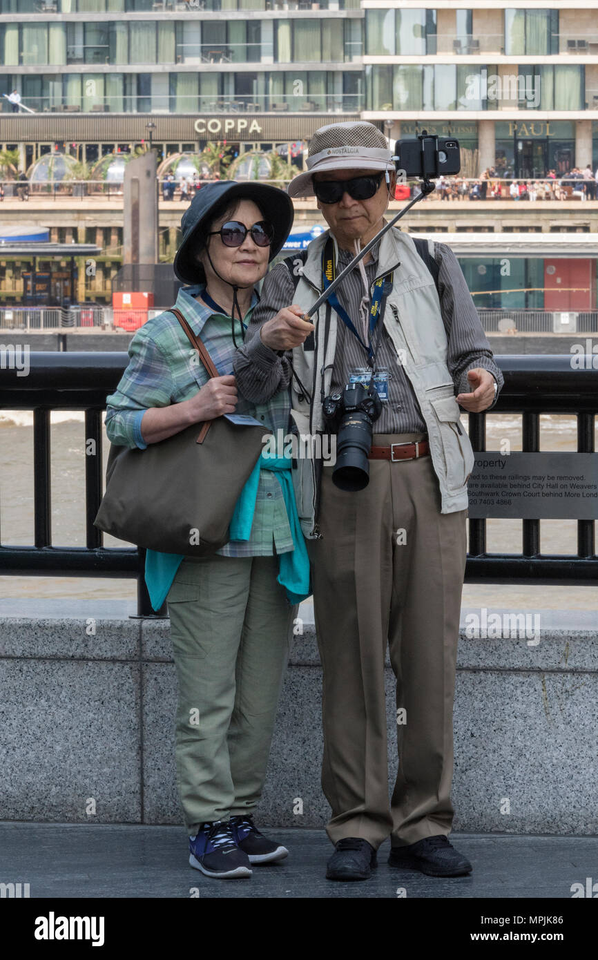 a chinese or japanese couple in retirement on a trip to london as ...