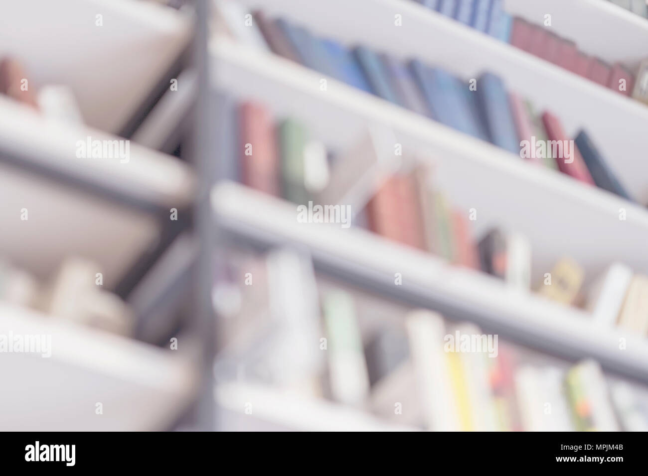 Abstract blurred bookshelves with books in public library, book store ...