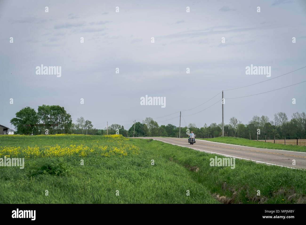 Motorcycle driving through Indiana backroad Stock Photo - Alamy