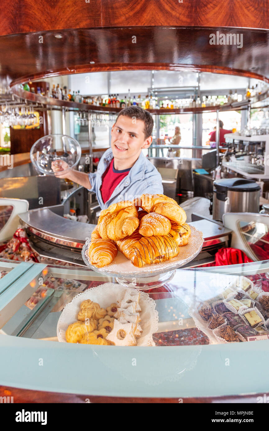 Selective focus on a fresh tasty croissant professional baker is ...