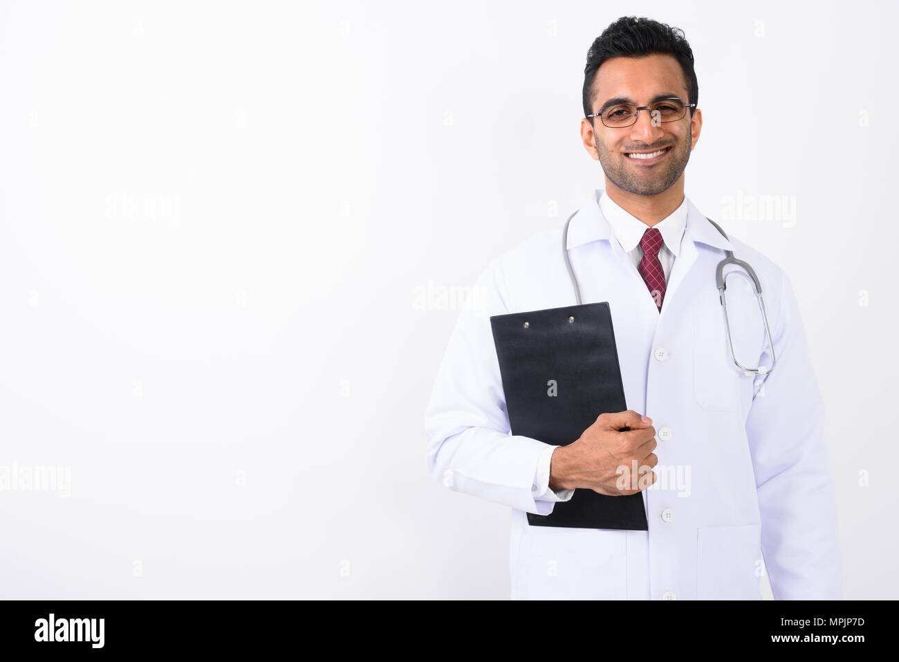 Young handsome Indian man doctor against white background Stock Photo ...
