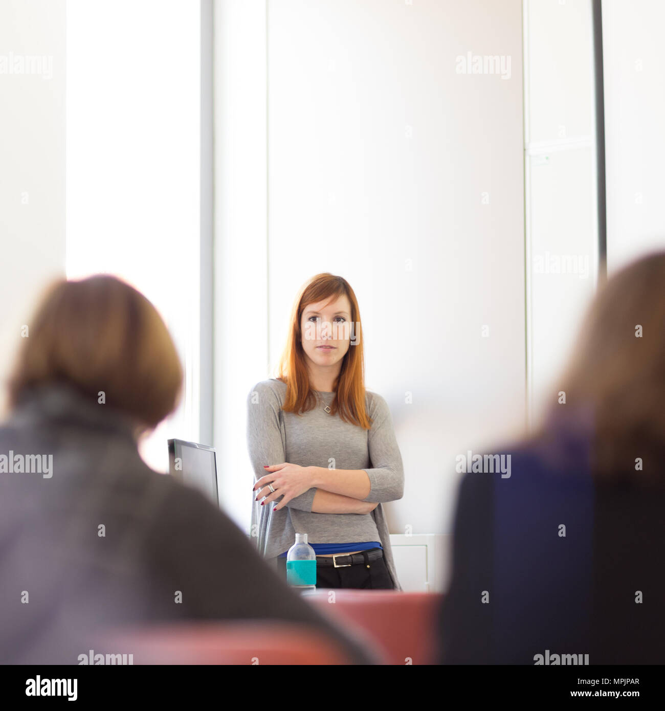 Woman giving presentation in lecture hall at university Stock Photo - Alamy