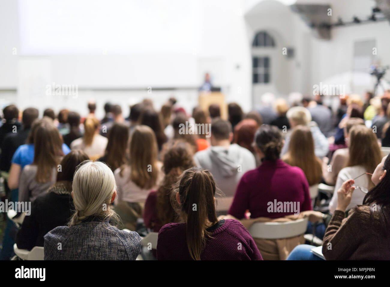 Woman giving presentation in lecture hall at university Stock Photo - Alamy
