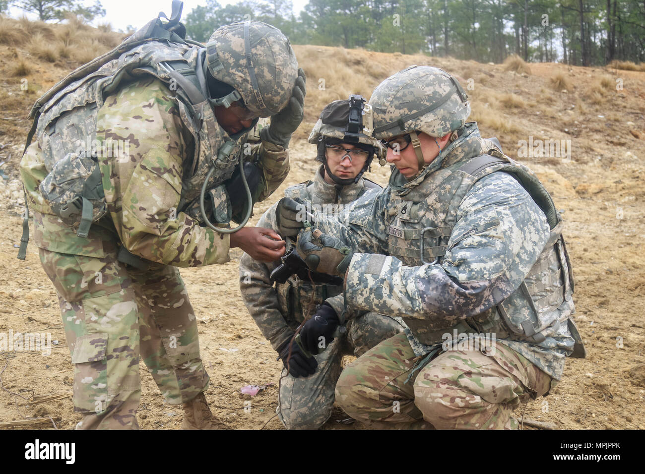 Staff Sgt. Roberts demonstrates correct placement of the charging pin ...