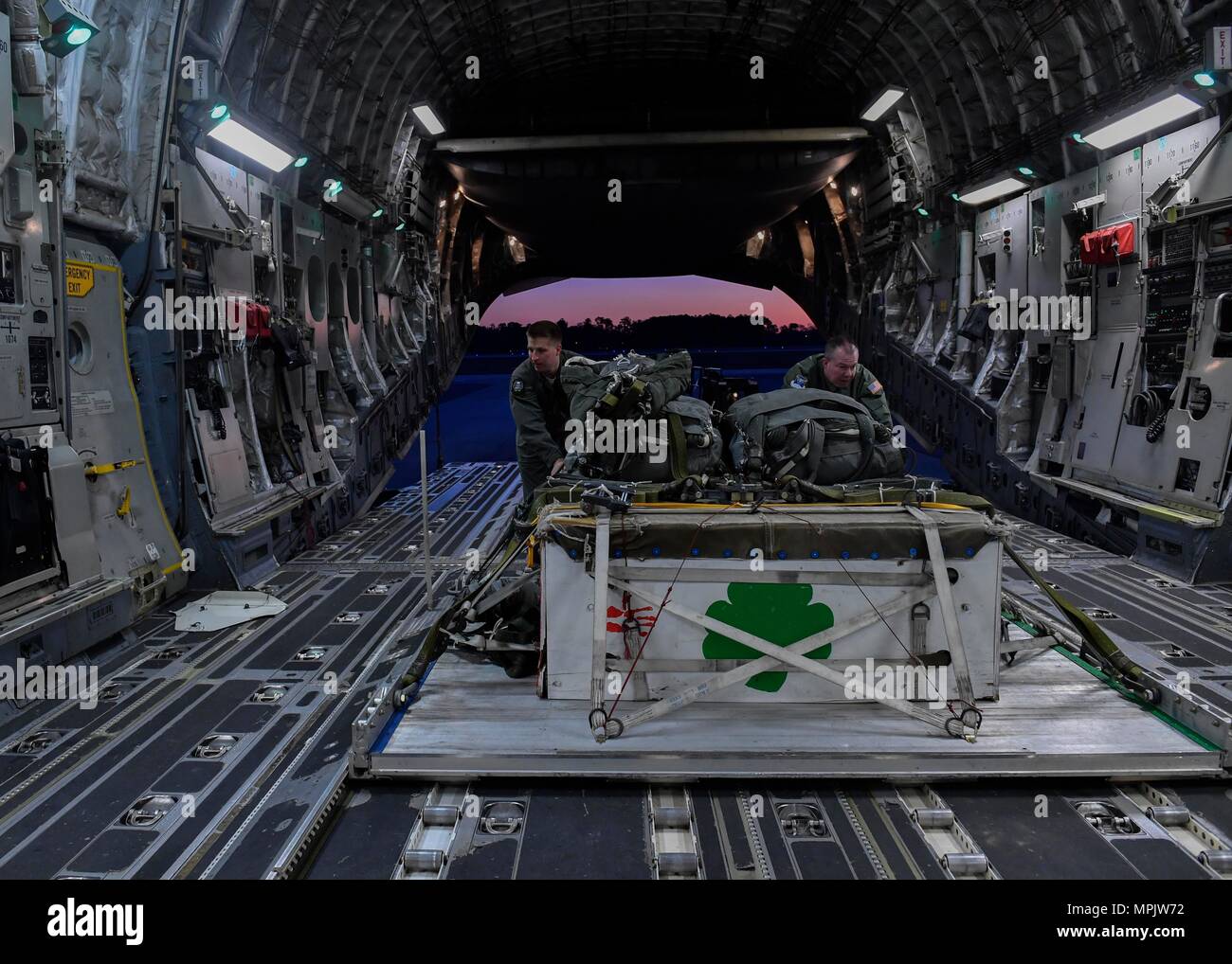 Senior Airman Grant Smart, left,15th Airlift Squadron (AS) loadmaster ...