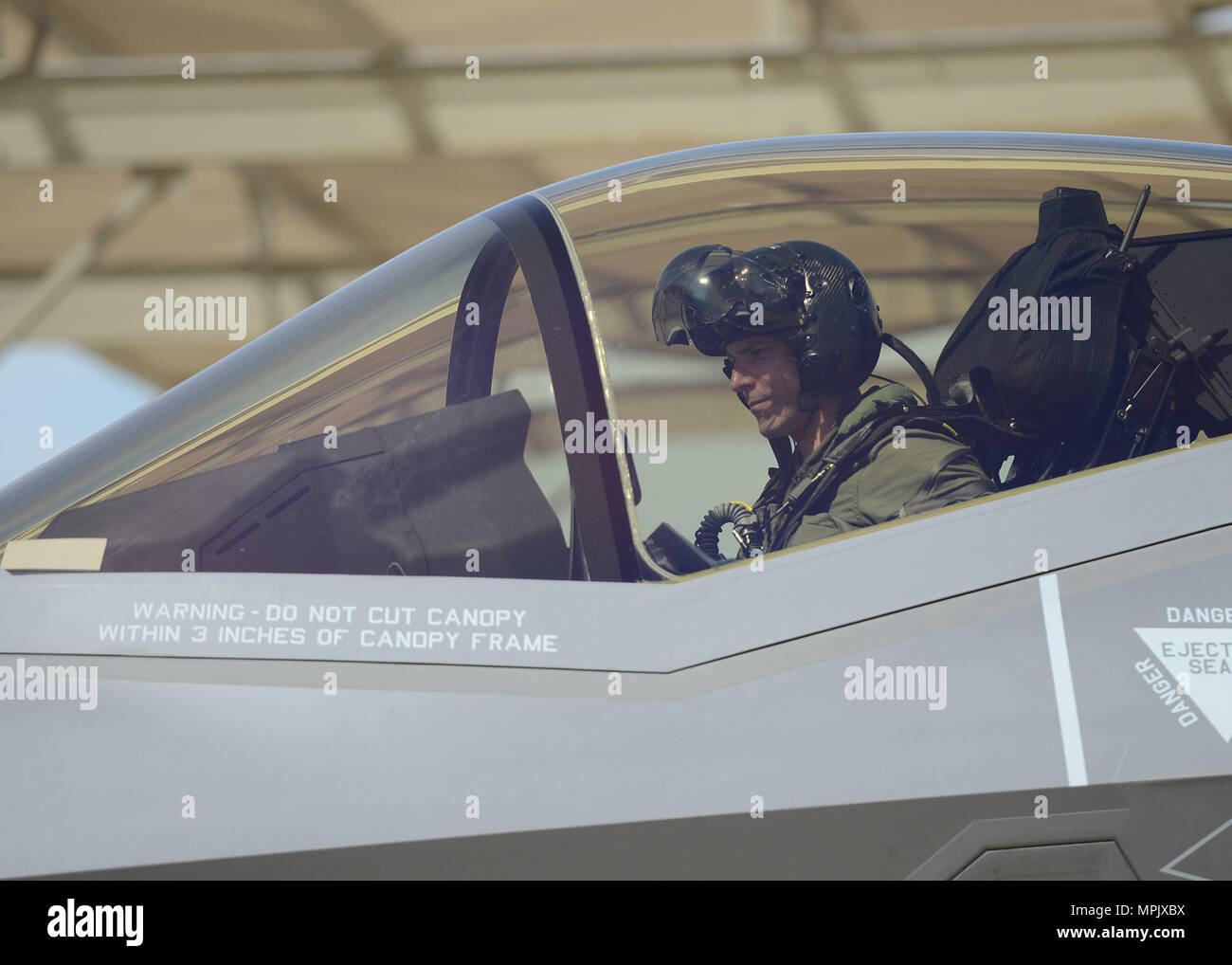 A 63rd Fighter Squadron pilot sits in the cockpit of an F-35 Lightning ...