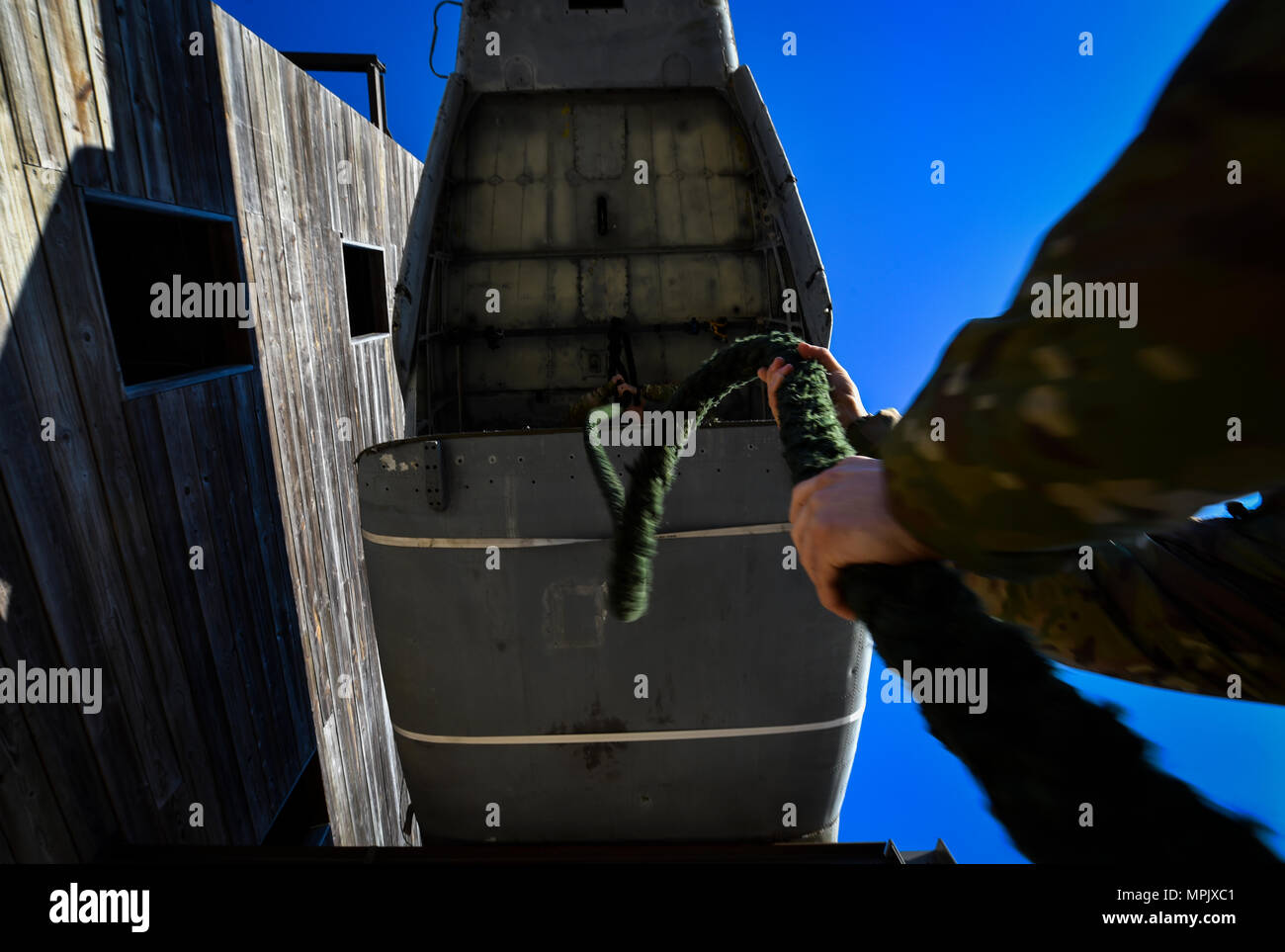 A Soldier with the 1st Battalion, 10th Special Forces Group, holds a ...