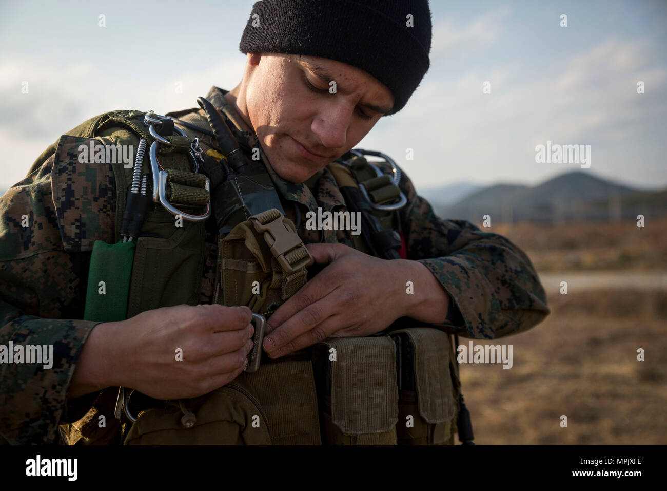 Cpl. Dominic Lopez straps into his parachute at Josari drop zone ...