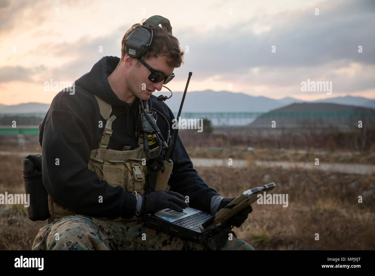 U.S. Marine Cpl. Alex Thill sets up communication with the command ...