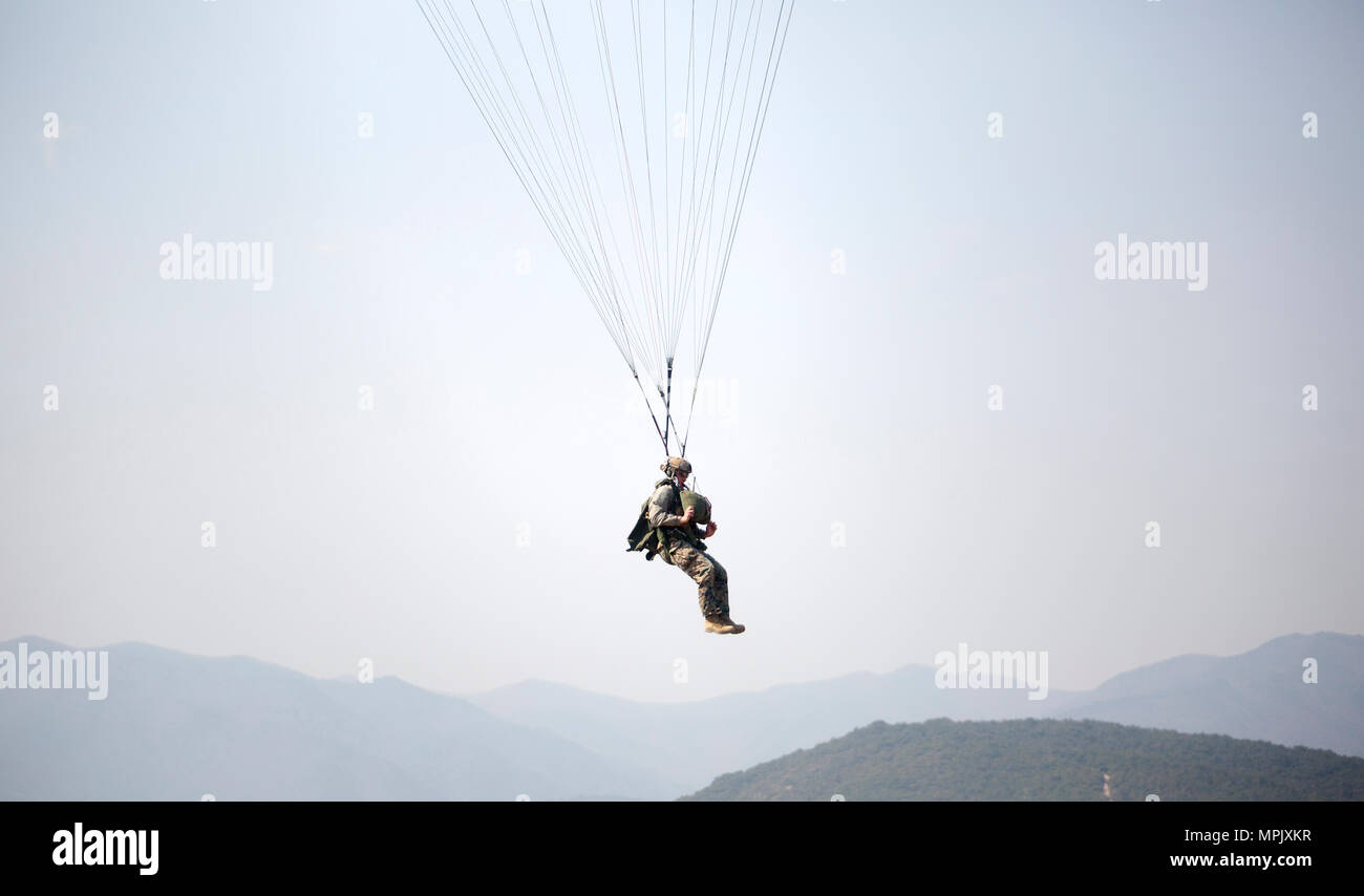 U.S. Marine Cpl. Alex Thill glides through the air during parachute ...