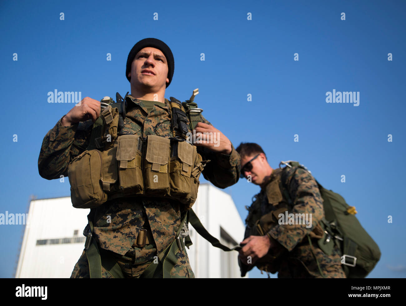 U.S. Marine Cpl. Dominic Lopez prepares his canopy before parachute ...