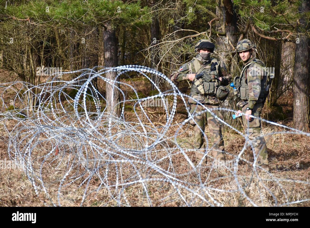 French soldiers set up concertina wire for defensive operations during ... French soldiers set up concertina wire for defensive operations during ...