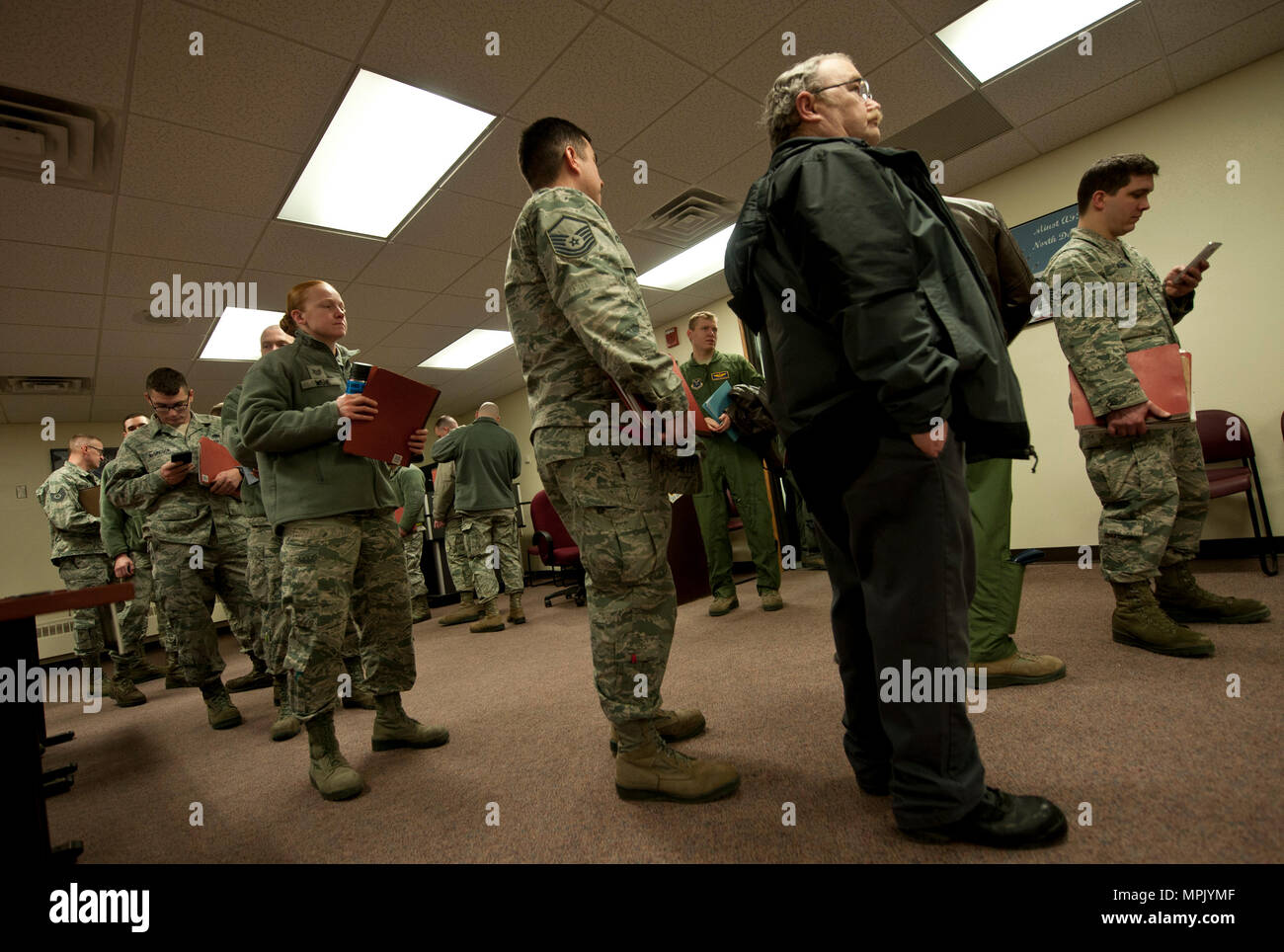 Deployers wait in a personnel deployment function line at Minot Air Force Base, N.D., Feb. 23 ...