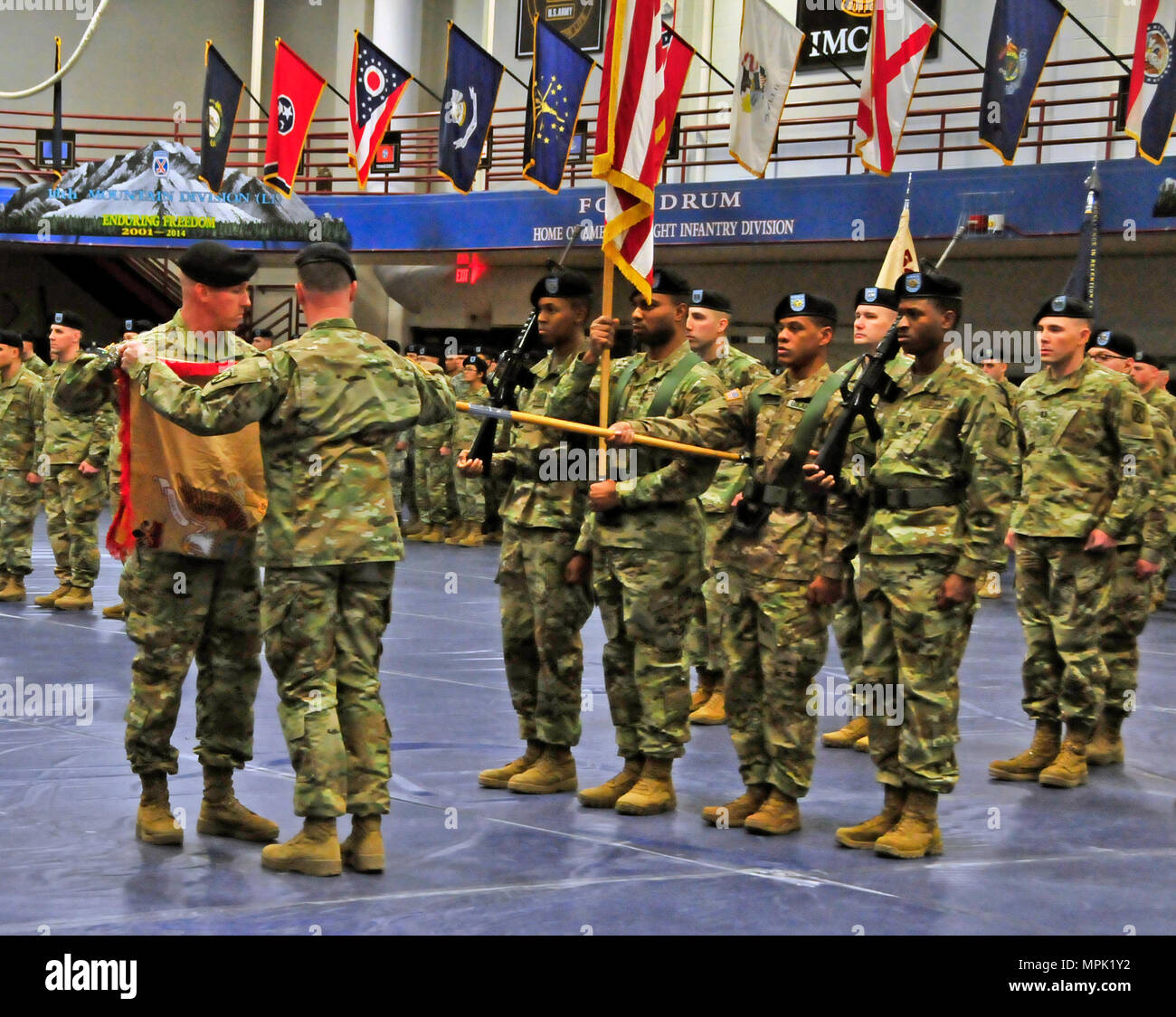 Maj. Thomas Pfarr and Master Sgt. Benjamin Brink furl the colors of the ...