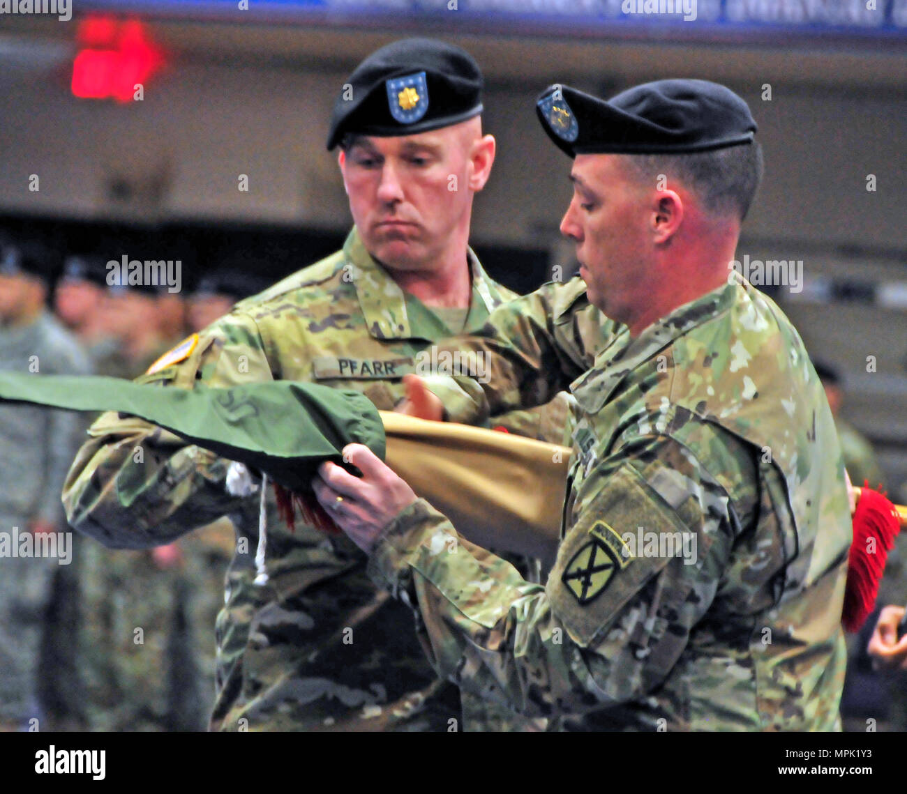 Maj. Thomas Pfarr and Master Sgt. Benjamin Brink case the colors of the ...