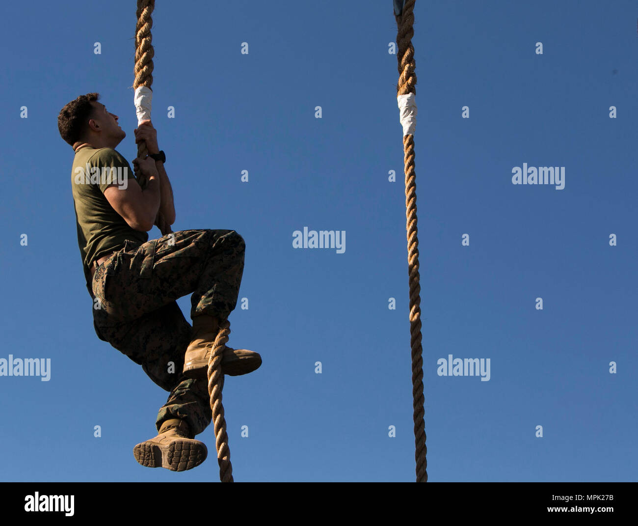 A Marine clears an obstacle during the obstacle course portion of the ...
