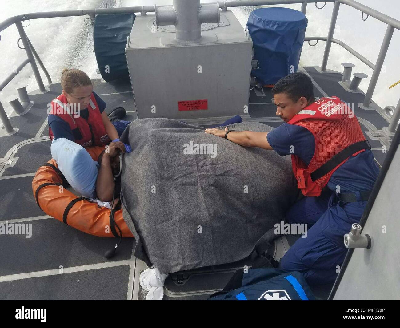 Seaman Martin Sissac and Petty Officer 3rd class Kaylee Harding tend to ...