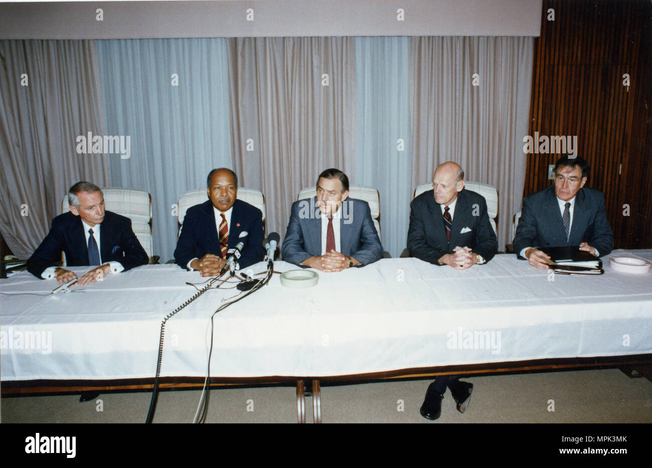 FIVE MEN AT THE TABLE HAVING A MEETING Stock Photo - Alamy