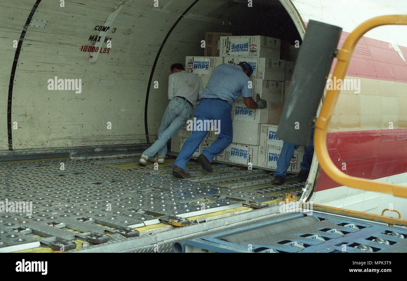 MEN LOADING PACKAGES ON A PLANE Stock Photo - Alamy