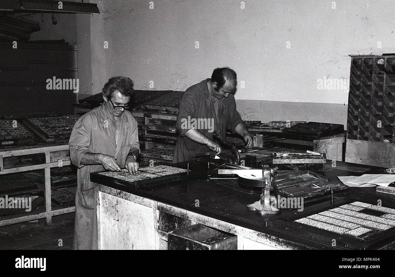 MEN OBSERVING MACHINE IN FACTORY Stock Photo - Alamy