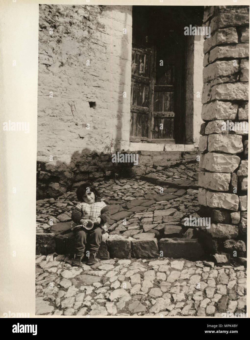 A PHOTO OF A CHILD SITTING ON A STEP Stock Photo - Alamy