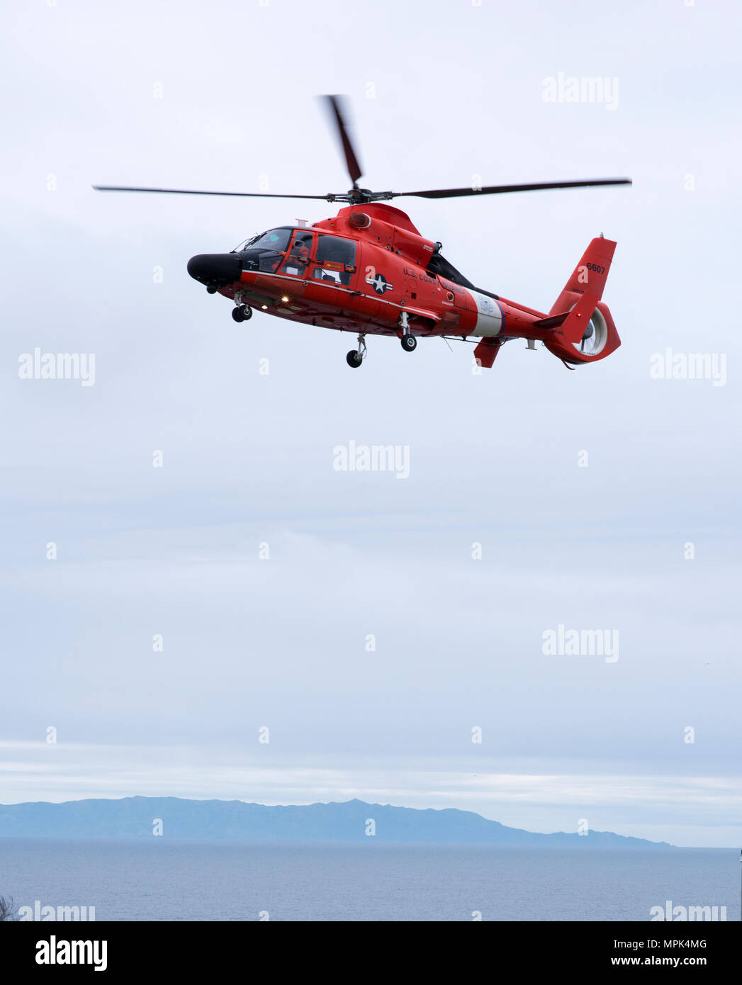 A Coast Guard MH-65 Dolphin helicopter flies over Point Vicente ...