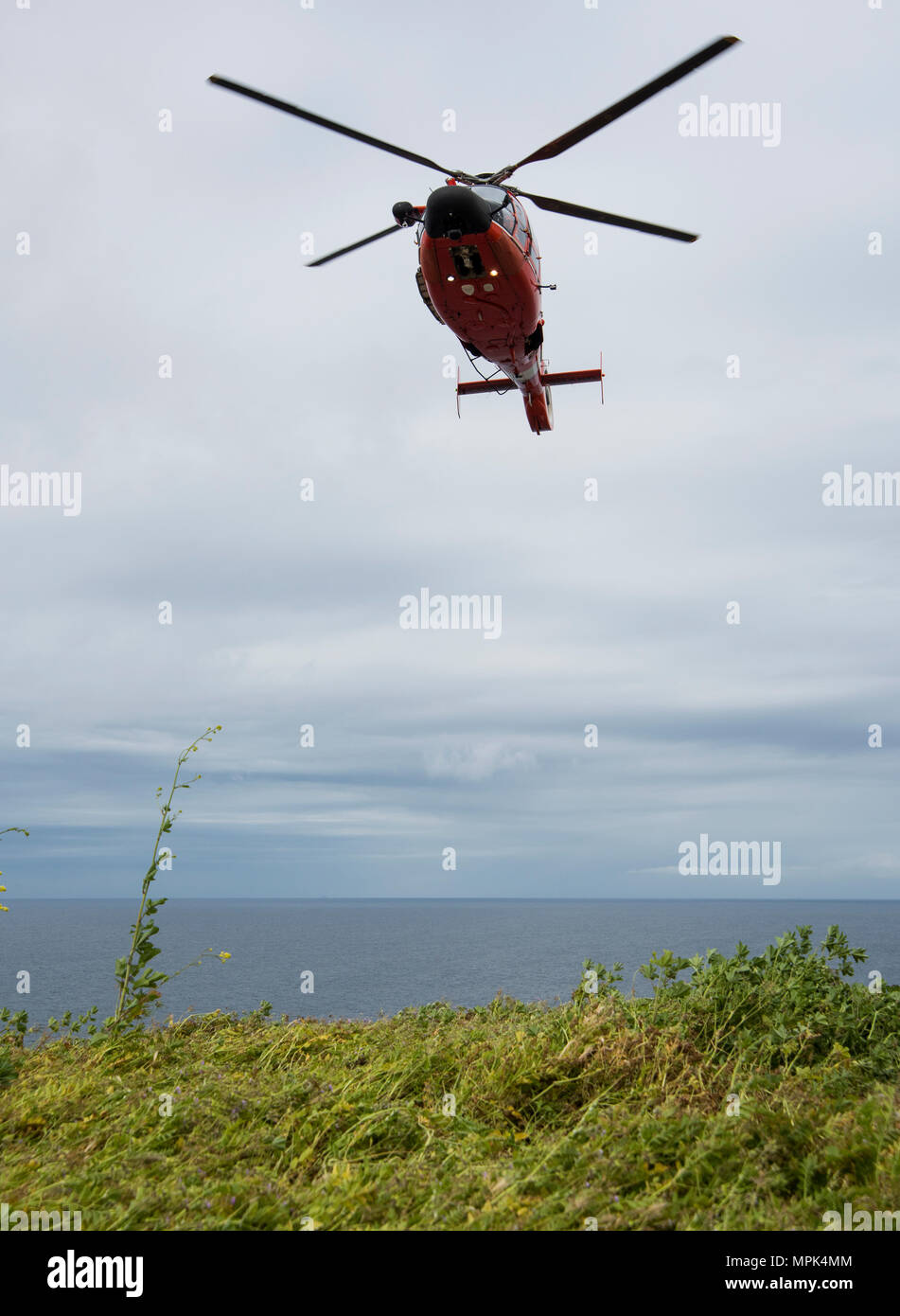 A Coast Guard MH-65 Dolphin helicopter flies over Point Vicente ...