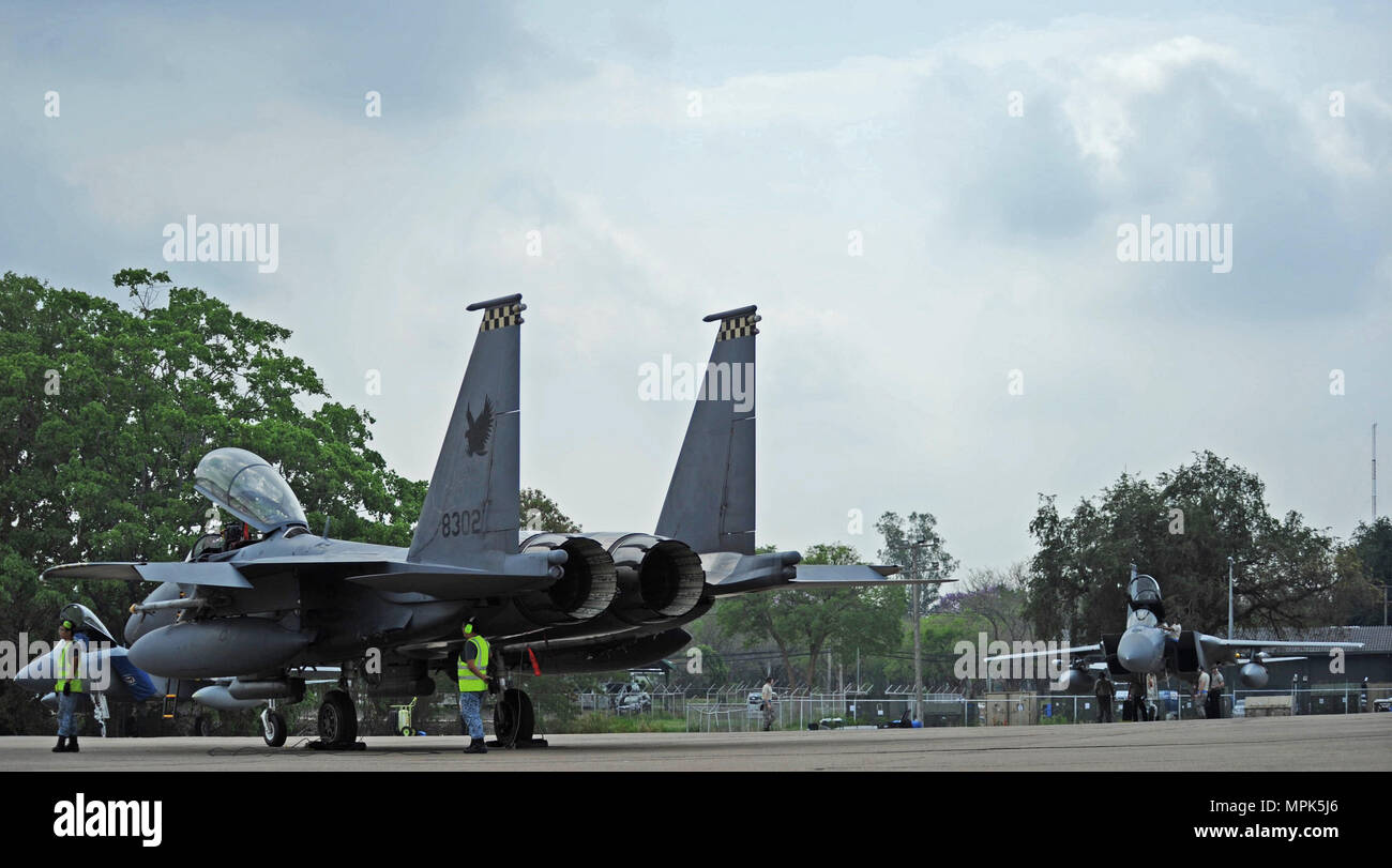 A Republic of Singapore air force F-15 (front) sits across from a U.S ...