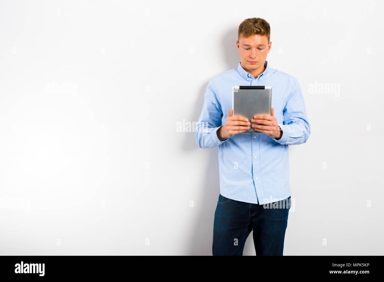 Young man looking up standing hi-res stock photography and images - Alamy