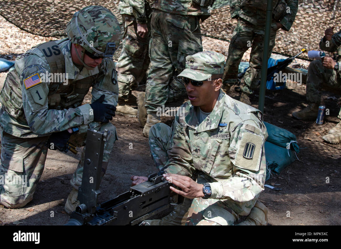 A U.S. Army infantryman instructs a fellow Soldier on performing a ...