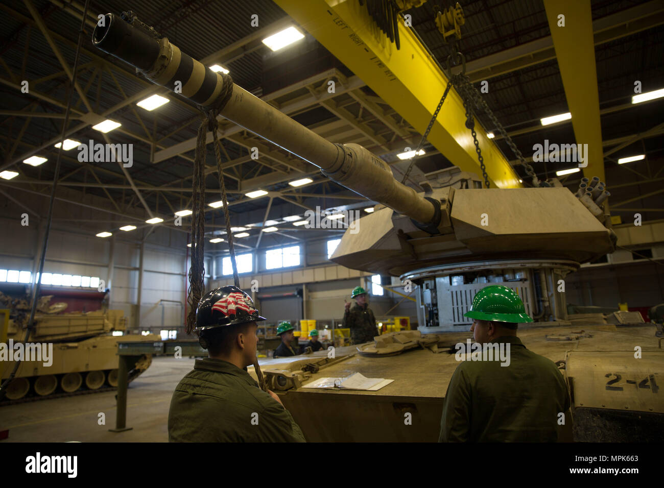 Marines hold ropes to steady an M1A1 Abrams tank’s 120mm turret before ...