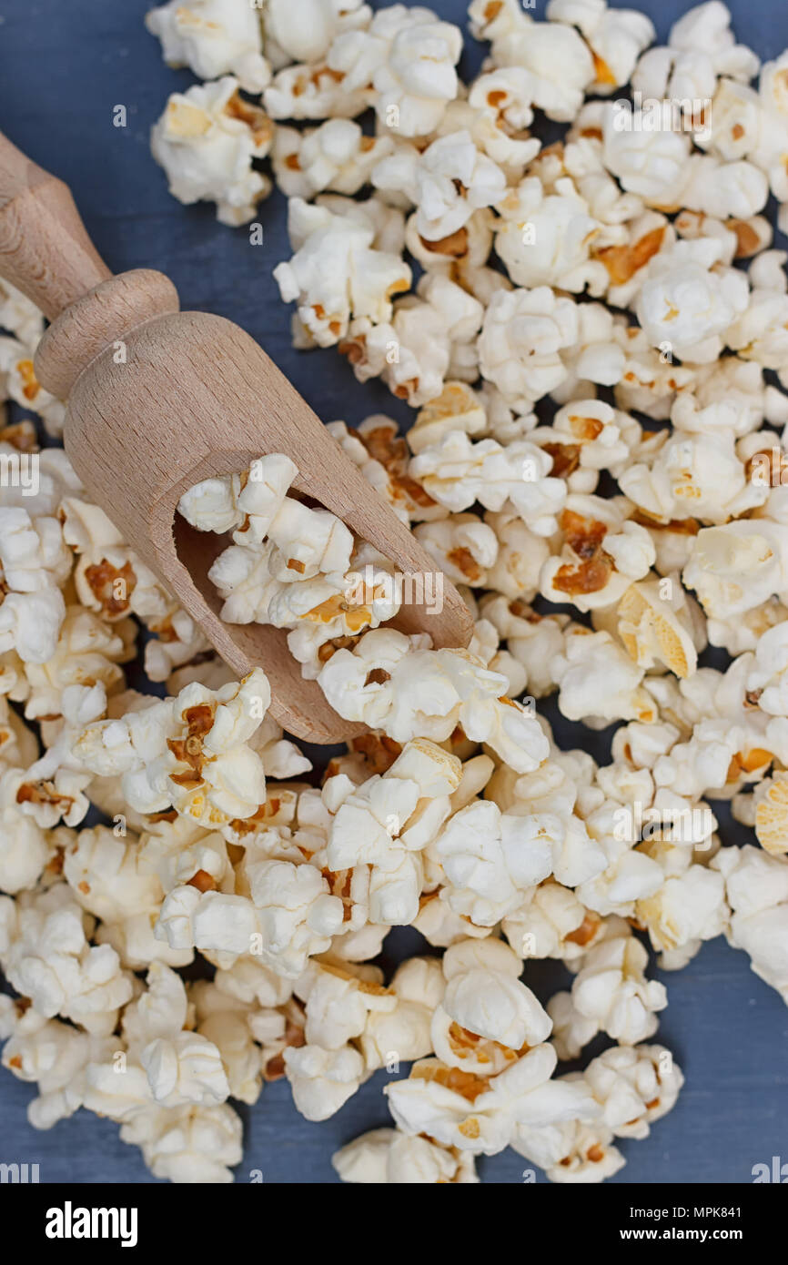 A lot of popcorn and a small wooden spatula Stock Photo - Alamy