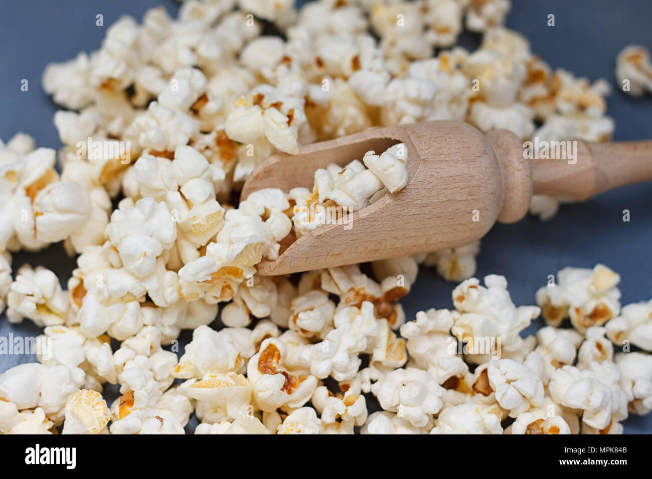 A lot of popcorn and a small wooden spatula Stock Photo - Alamy