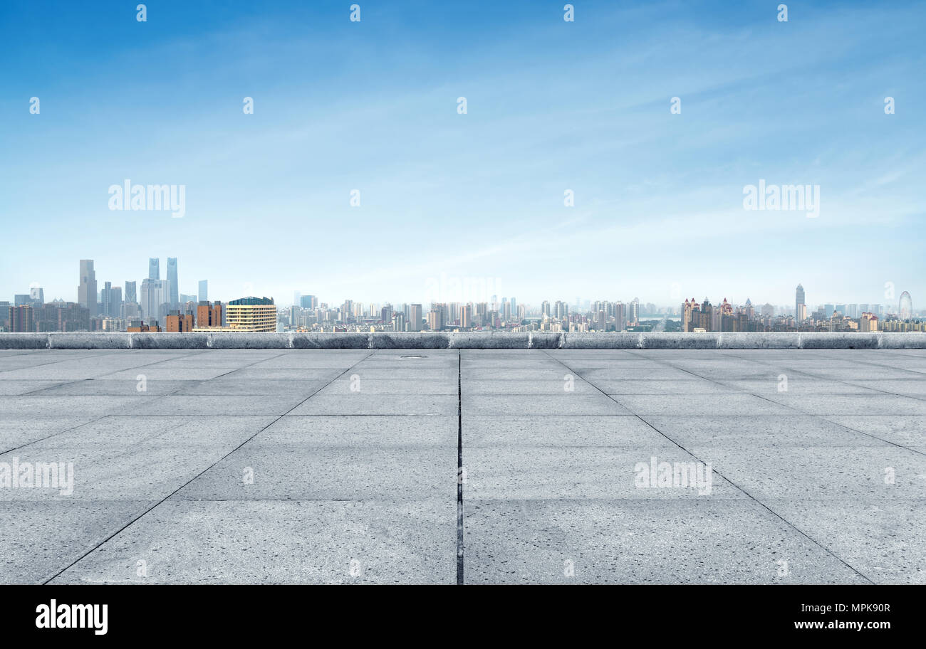 empty brick floor with cityscape of modern city Stock Photo - Alamy